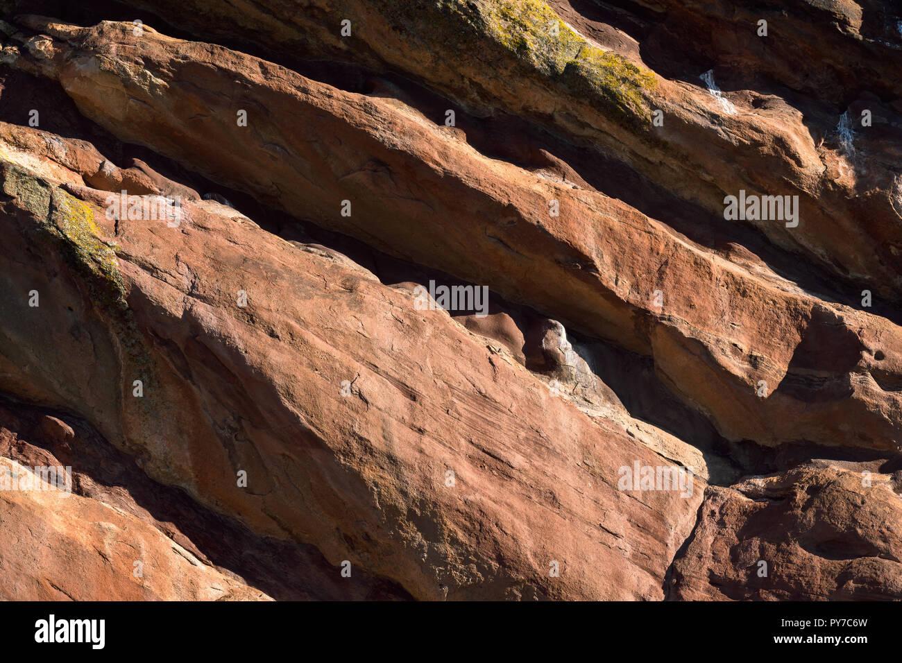 Red rock wind worn texture at sunrise Stock Photo - Alamy