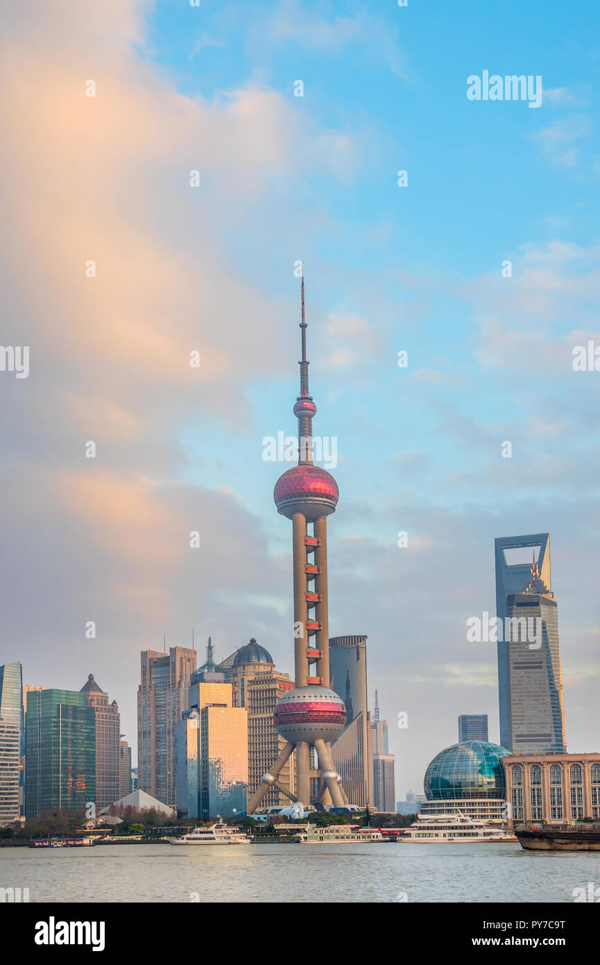 Famous Shanghai tv tower and city skyline in susnet light with cloudy ...
