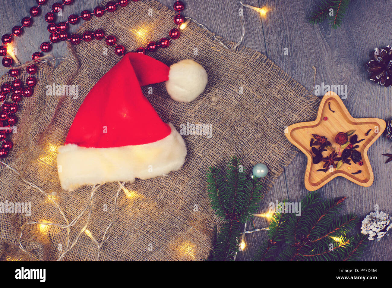 Christmas card with a red Santa Claus hat, a glowing garland and a ...