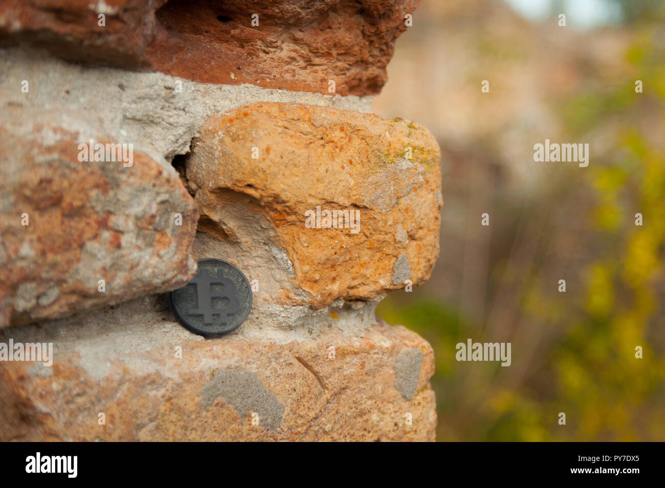 Bit coin on the old stone and brick wall Stock Photo - Alamy