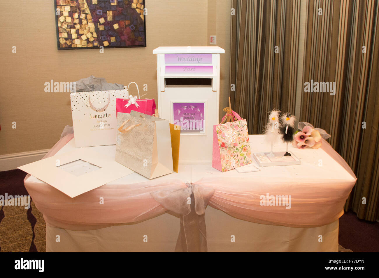 present table at a wedding day in a hotel reception room, with cards ...