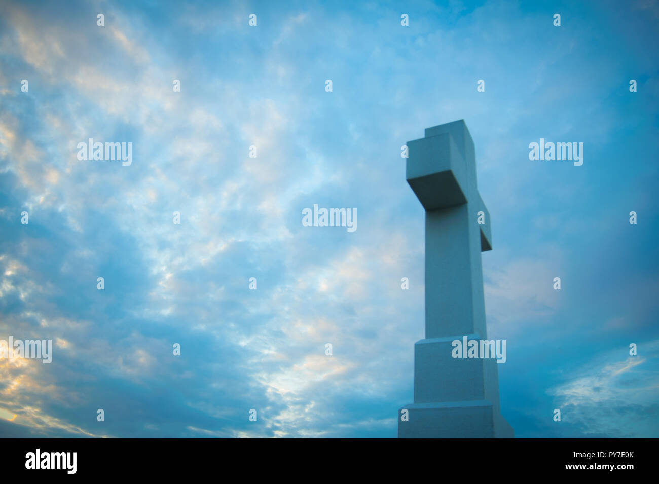 Massive Christian cross in the blue sky made from stone side view Stock ...