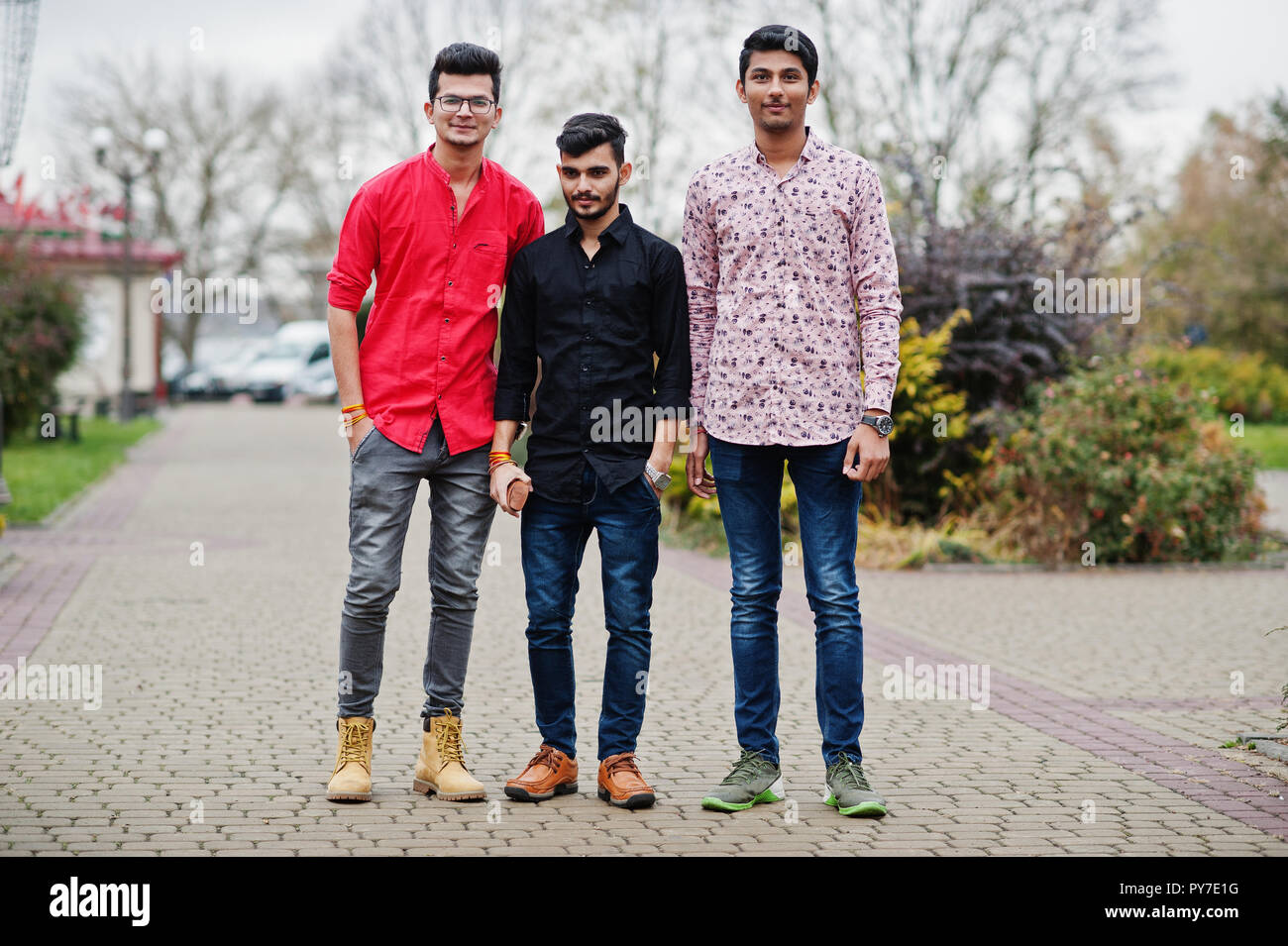 Three indian guys students friends walking on street Stock Photo - Alamy