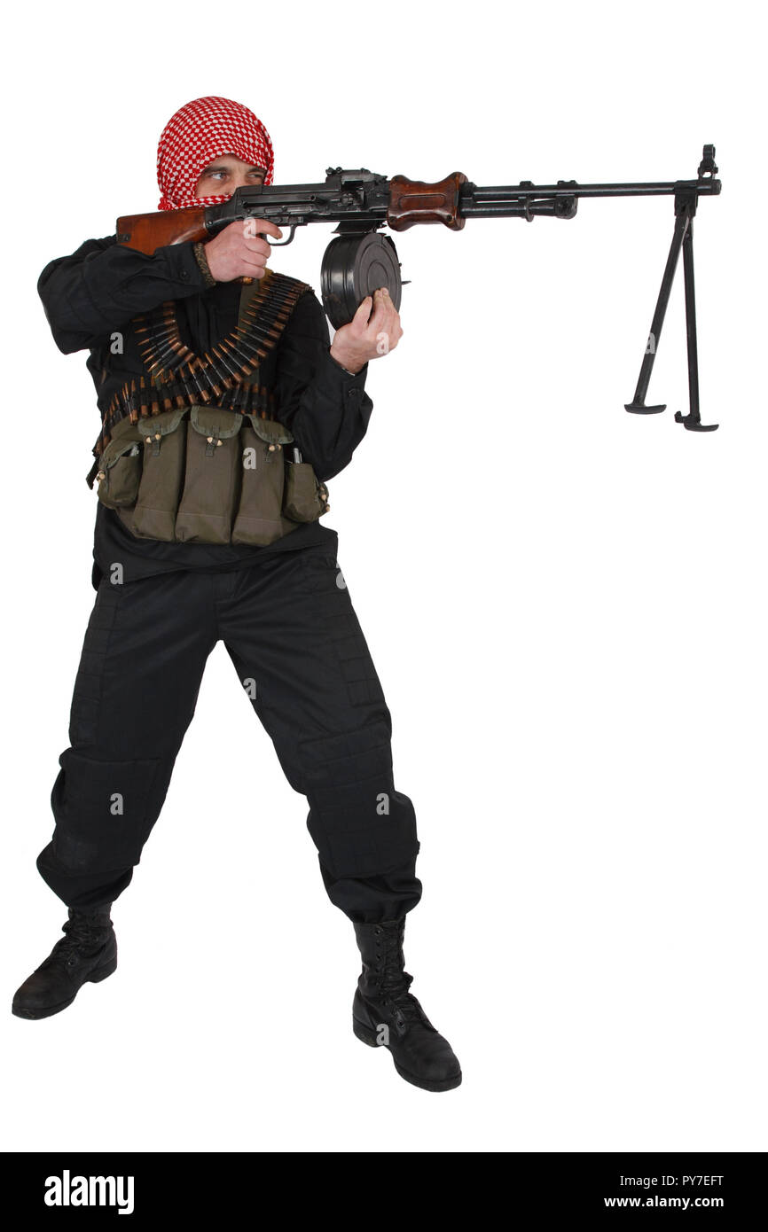 Rebel army soldier in black uniform with red kufiya holding machine gun ...