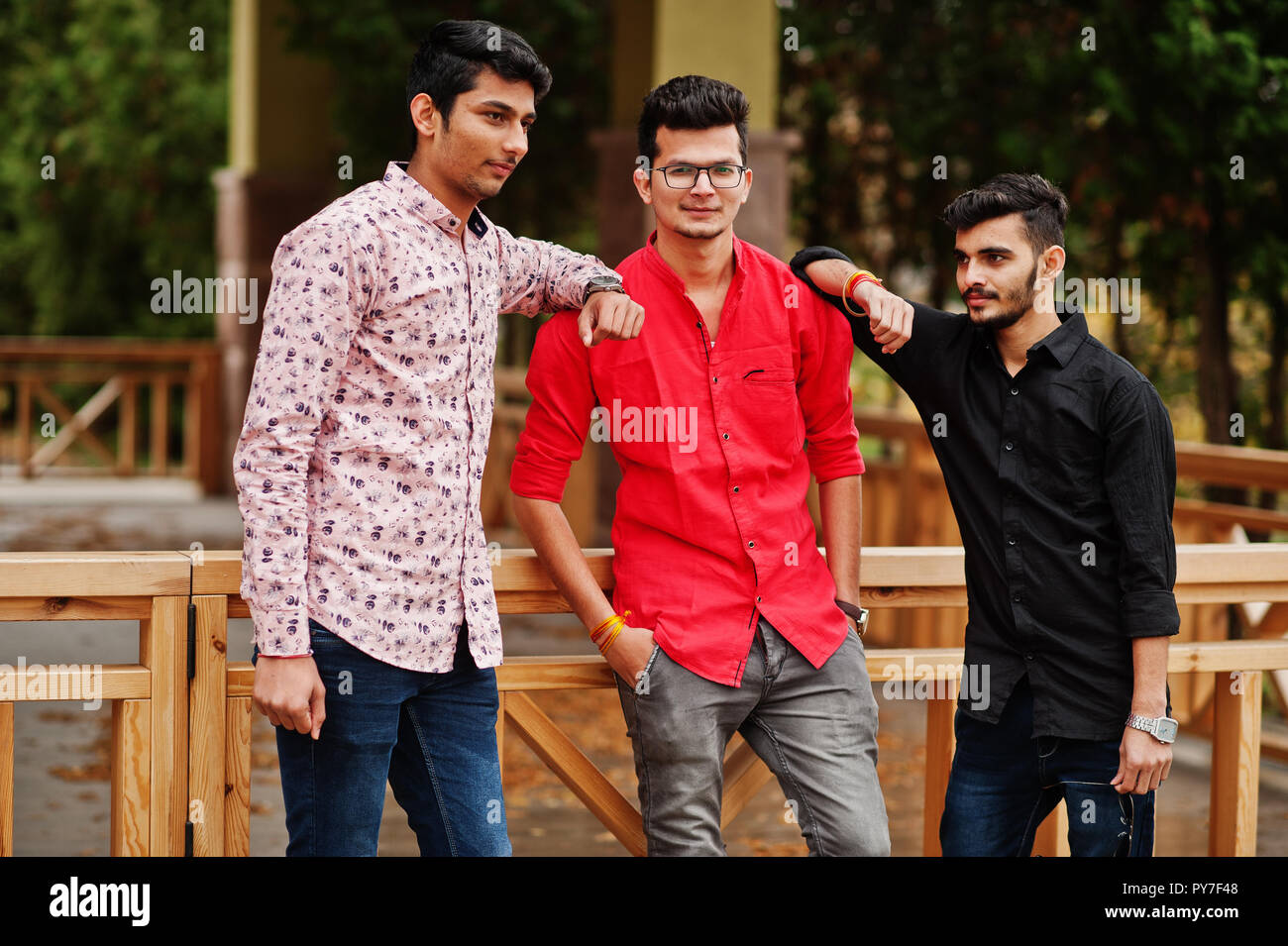 Three indian guys students friends walking on street Stock Photo - Alamy