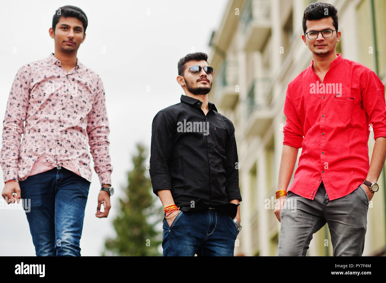 Three indian guys students friends walking on street Stock Photo - Alamy