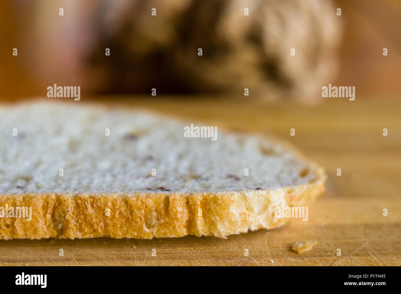 sliced whole wheat breads on a chopping Board Stock Photo - Alamy