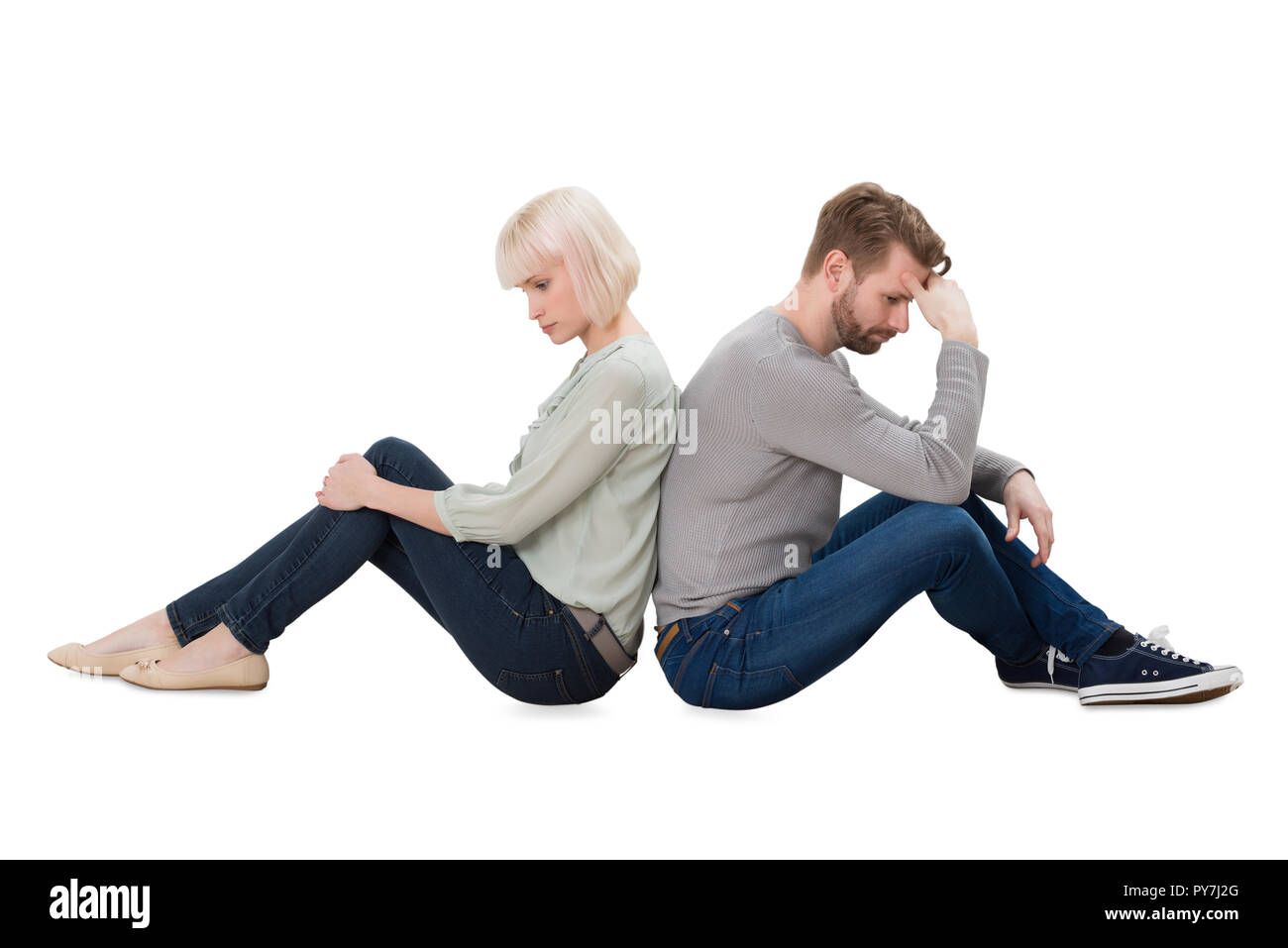 Upset Couple Sitting Back To Back On White Background Stock Photo - Alamy