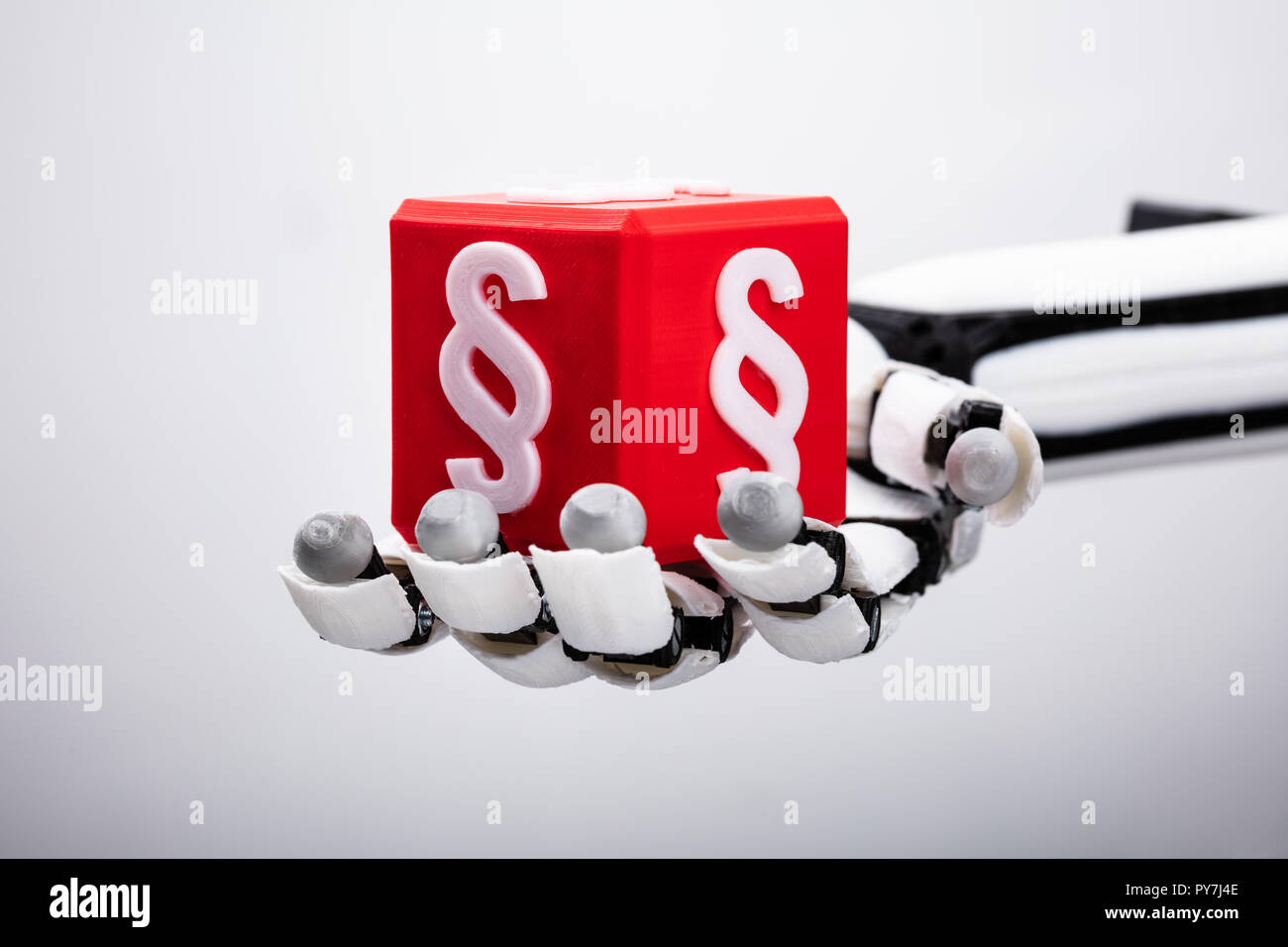 Robotic Hand Holding Red Cubic Block With Paragraph Symbol On Gray ...