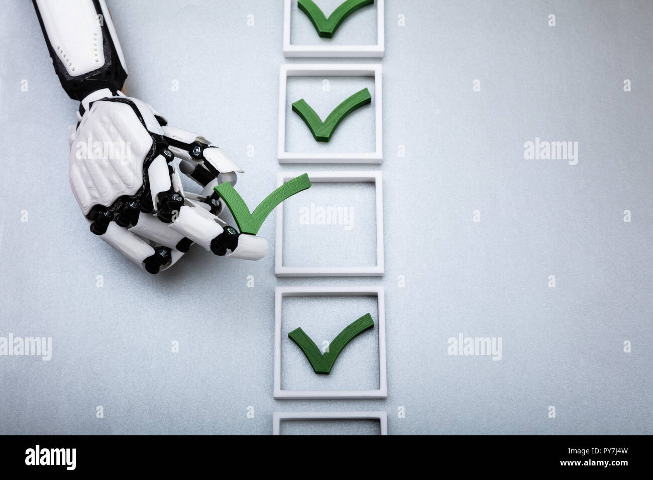 Robotic Hand Placing Check Mark In Box On Grey Background Stock Photo ...