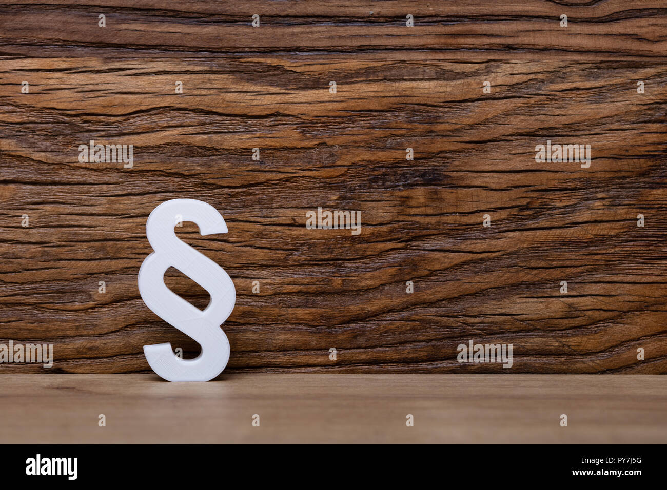 White Paragraph Sign Leaning On Wooden Wall Stock Photo - Alamy