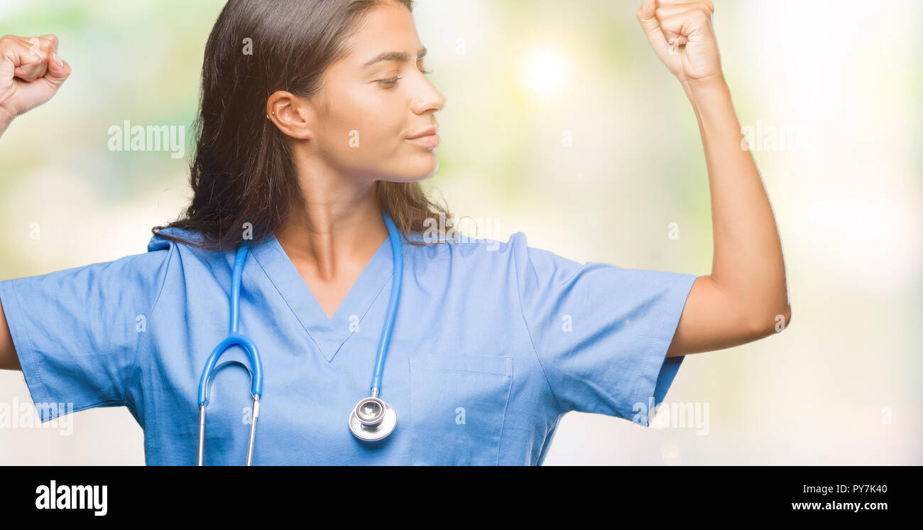 Young arab doctor surgeon woman over isolated background showing arms ...