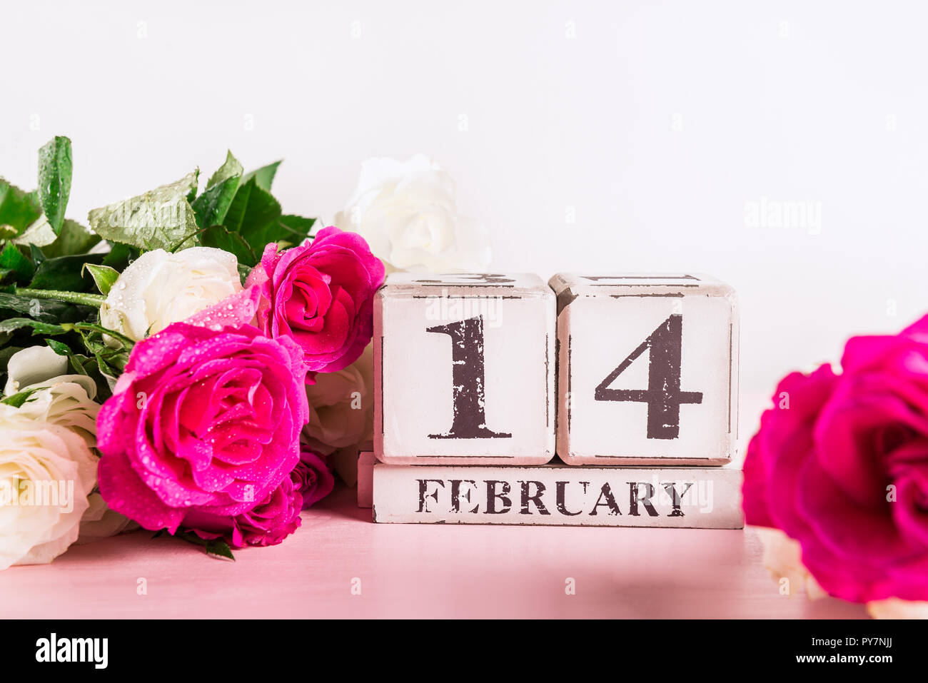 Bunch of White and Pink Roses for St Valentines Day with wooden block ...