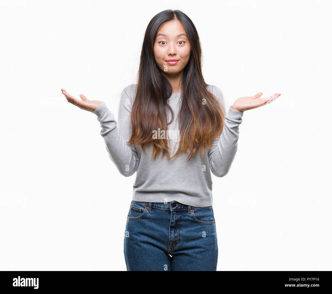 Young asian woman over isolated background clueless and confused ...
