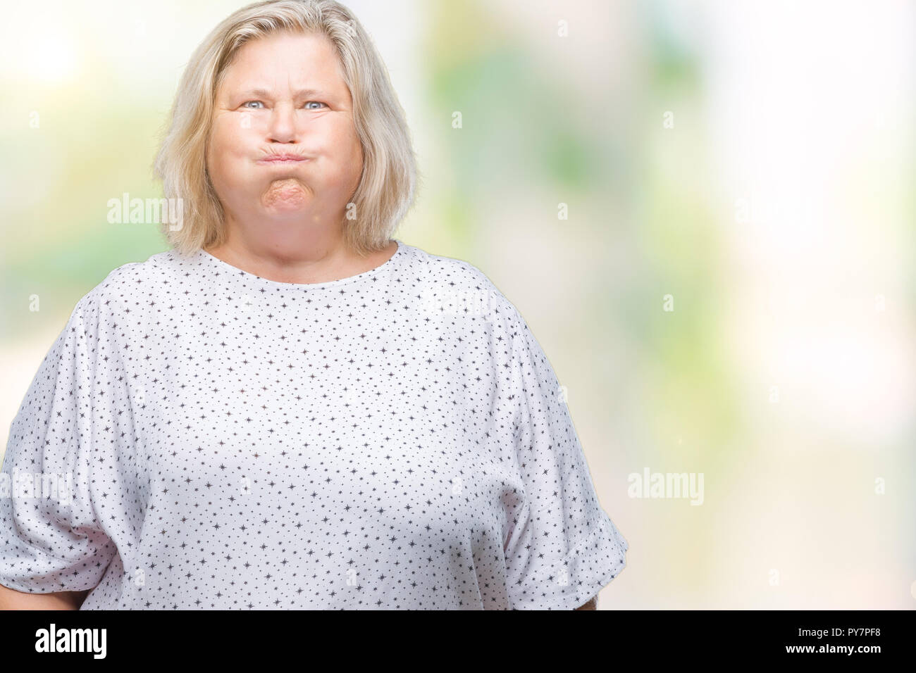 Senior plus size caucasian woman over isolated background puffing ...