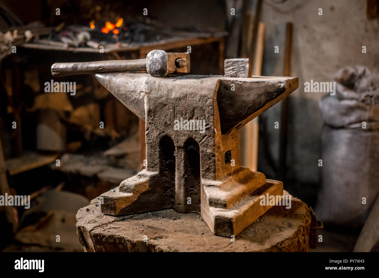 Old blacksmiths hammer on anvil in workshop read to be used for forging ...