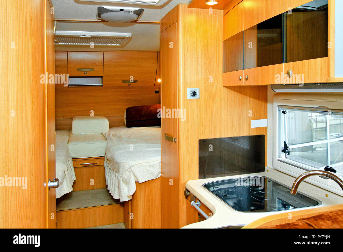 Interior of kitchen and bedroom in recreation vehicle Stock Photo - Alamy