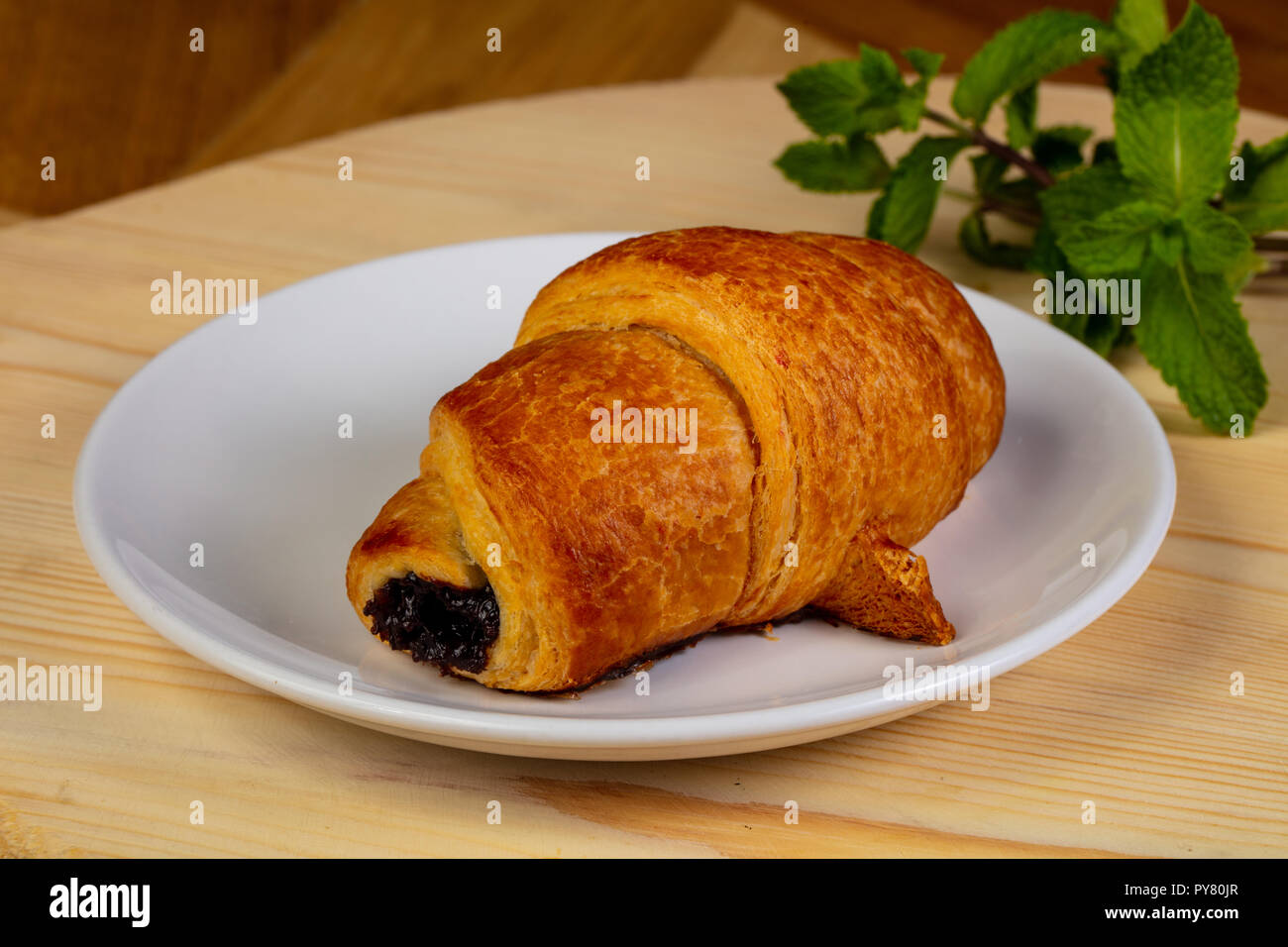 Croissant with chocolate served mint Stock Photo - Alamy