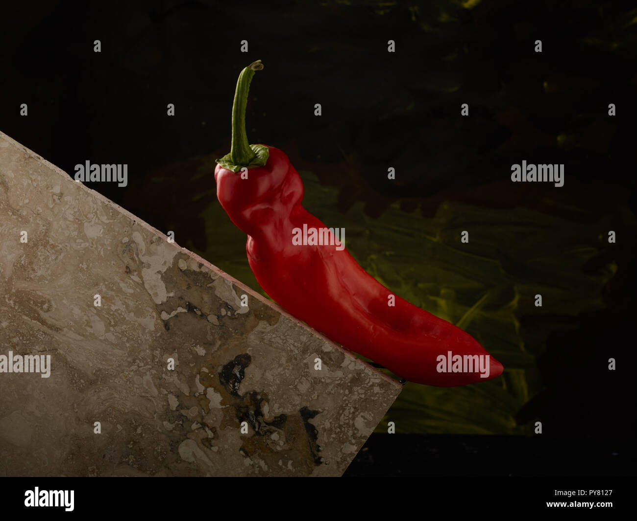 Red pepper on tile slope still-life Stock Photo - Alamy