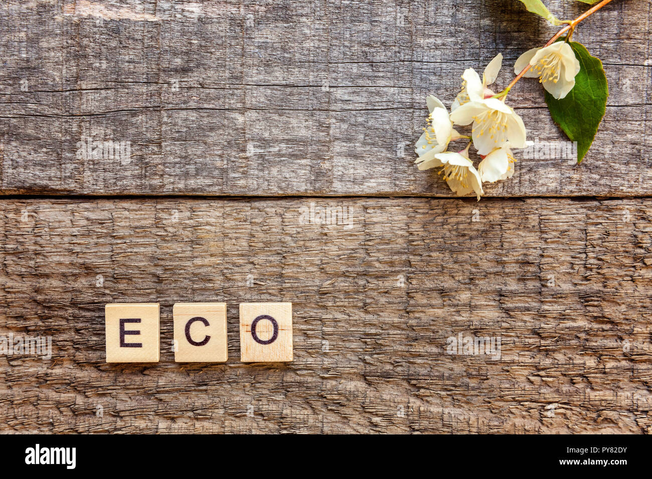 Inscription ECO letters word jasmine flower on old rustic wooden ...