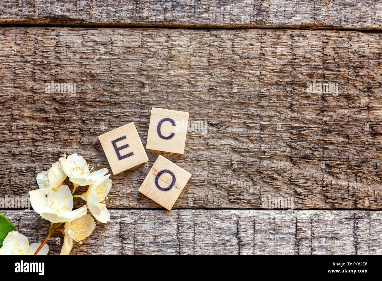 Inscription ECO letters word jasmine flower on old rustic wooden ...