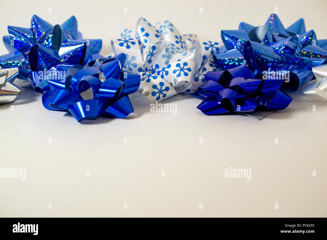 Multiple Christmas holiday bow ribbons in blue, dark blue, white. Room ...