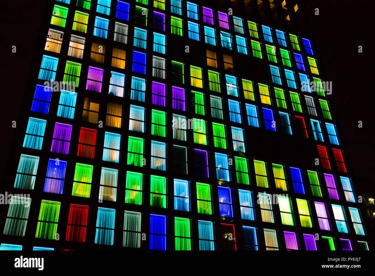 Colored windows texture. Windows illuminated by neon lights background ...