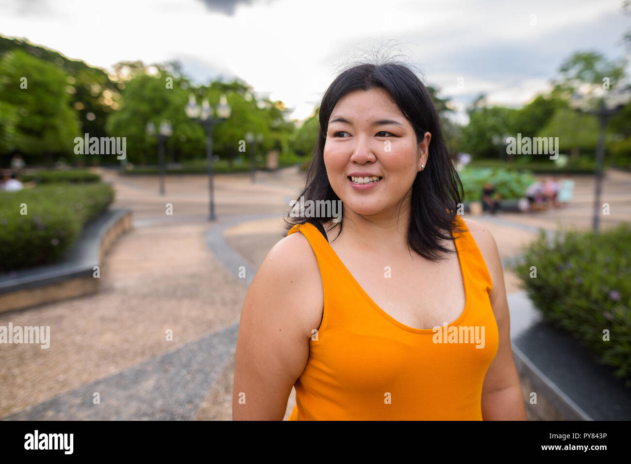 Happy overweight asian woman thinking hi-res stock photography and ...
