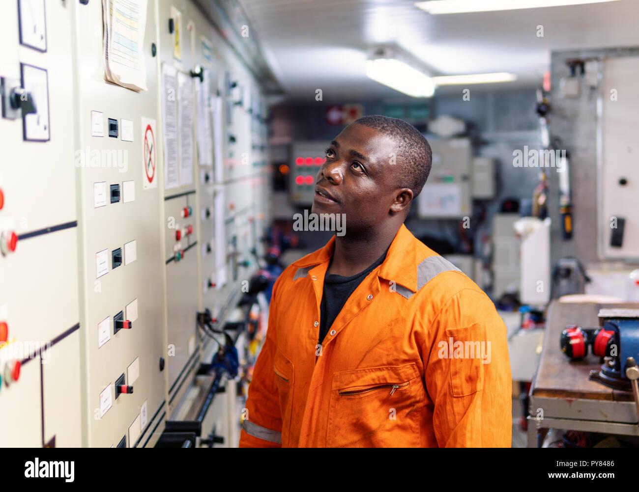 Marine engineer officer working in engine room Stock Photo - Alamy