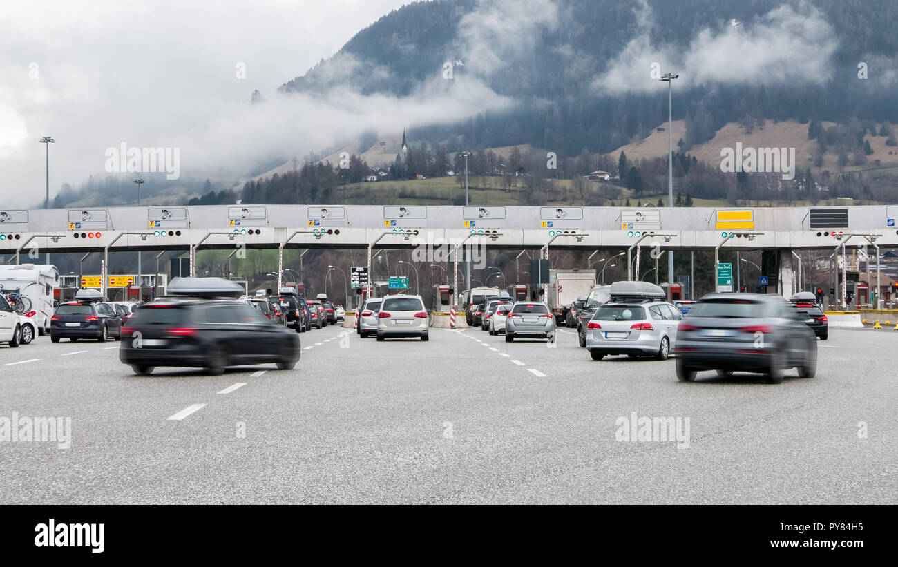 Many cars approaching toll gate on highway, mountain scenery Stock ...