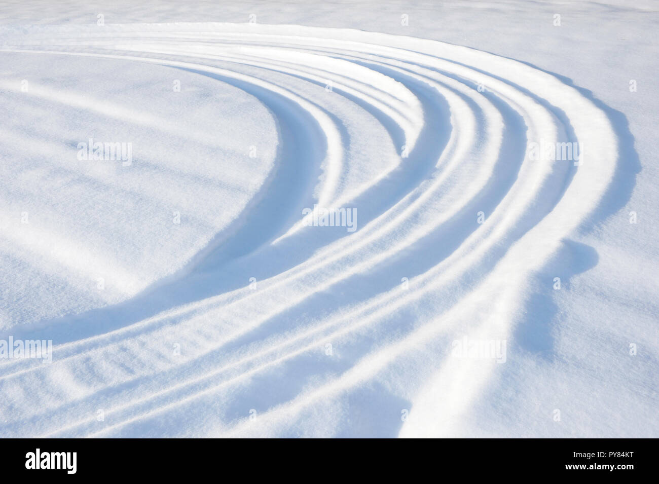Snowmobile and tire tracks in snow Stock Photo - Alamy