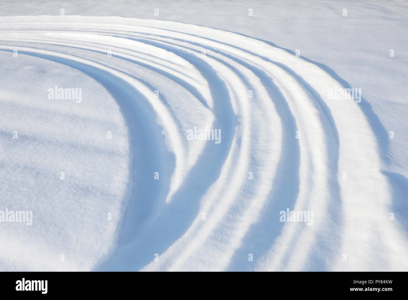 Snowmobile and tire tracks in snow Stock Photo - Alamy