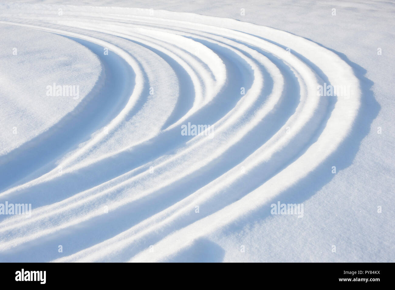 Snowmobile and tire tracks in snow Stock Photo - Alamy