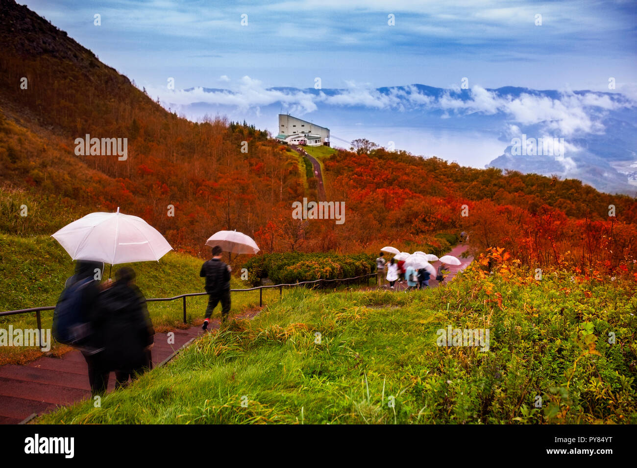 group of tourist walking in path way of showa-shinzan and usu ropeway ...