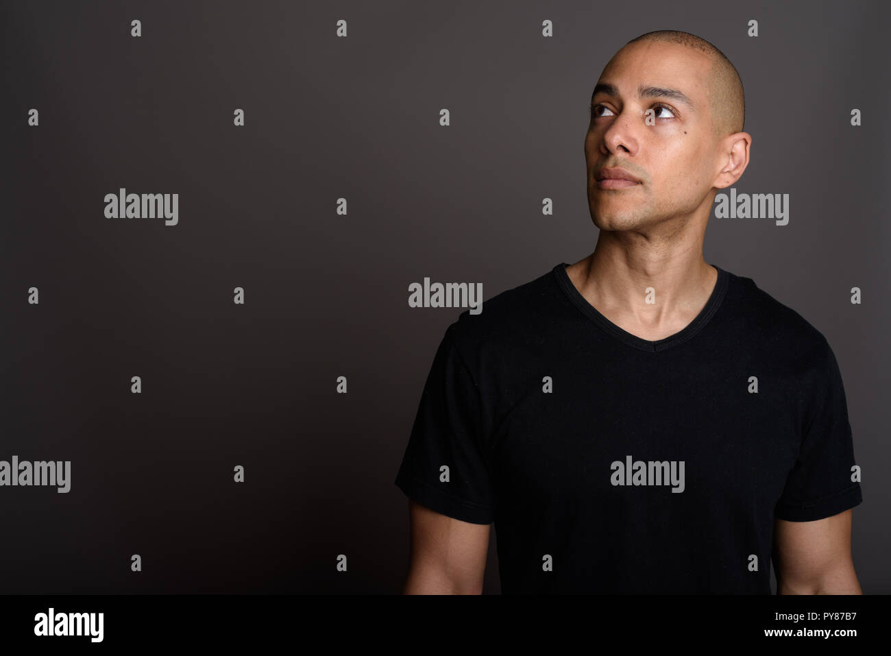 Handsome bald man thinking and looking up Stock Photo - Alamy