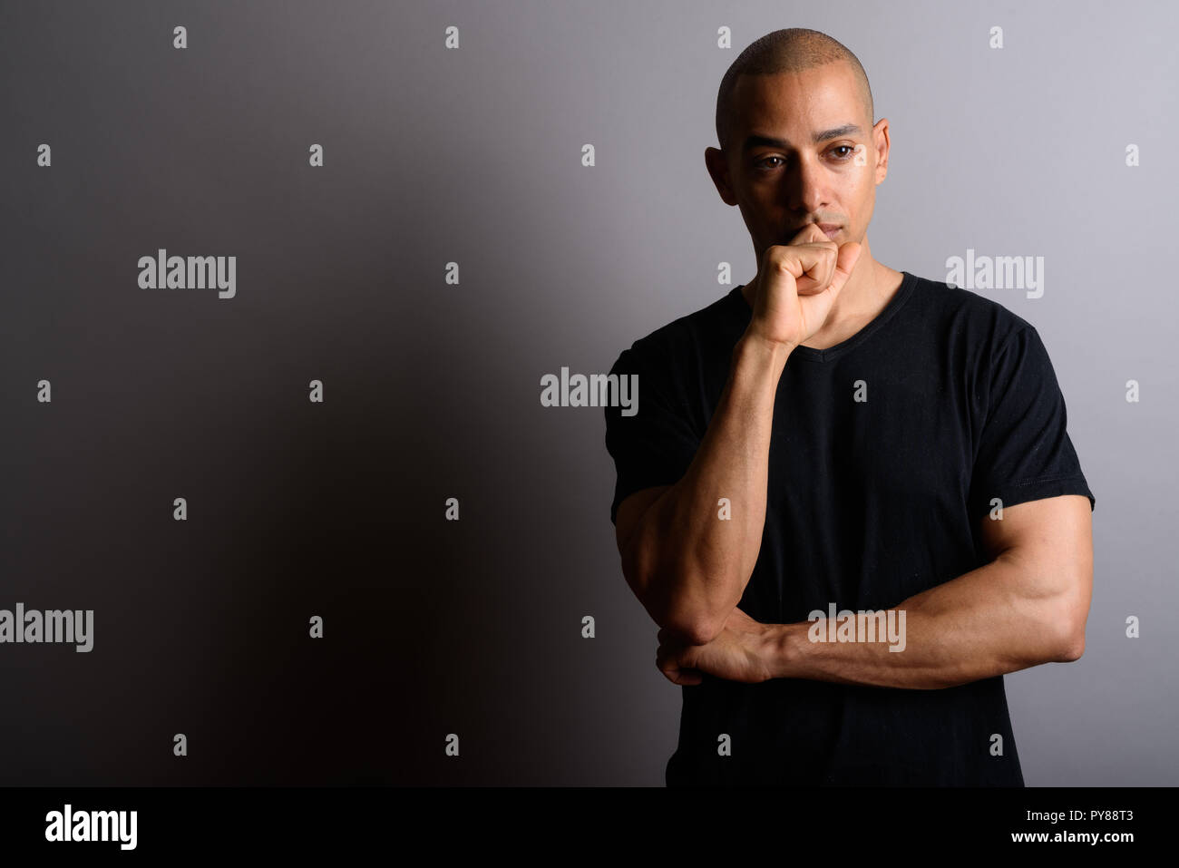 Stressed handsome bald man looking worried while thinking Stock Photo ...