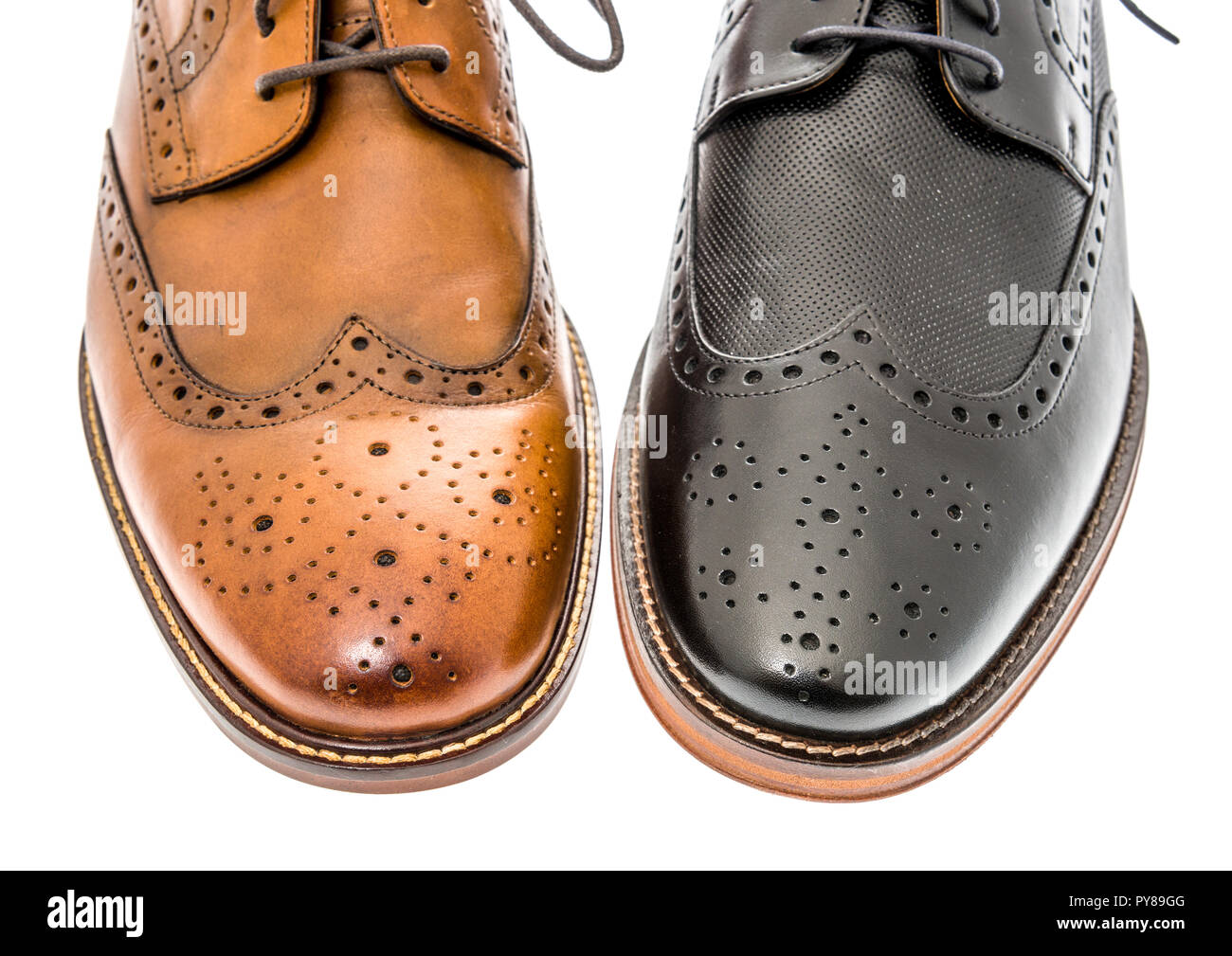A close-up shot of a pair of mens brown and black wingtip dress shoes ...