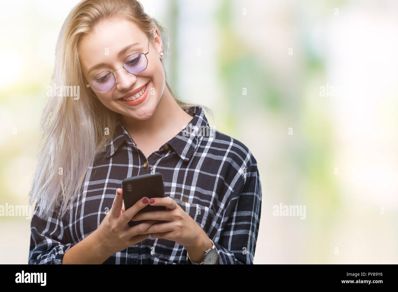 Young blonde woman texting sending message using smartphone over ...