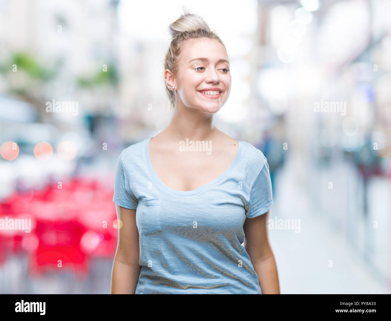 Young blonde woman over isolated background looking away to side with ...