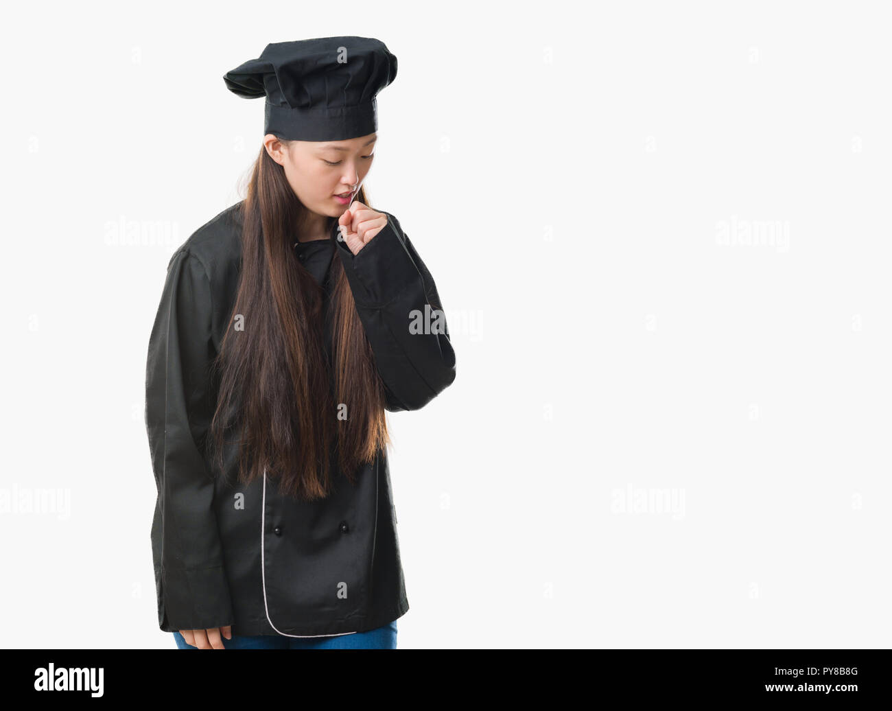 Young Chinese woman over isolated background wearing chef uniform ...