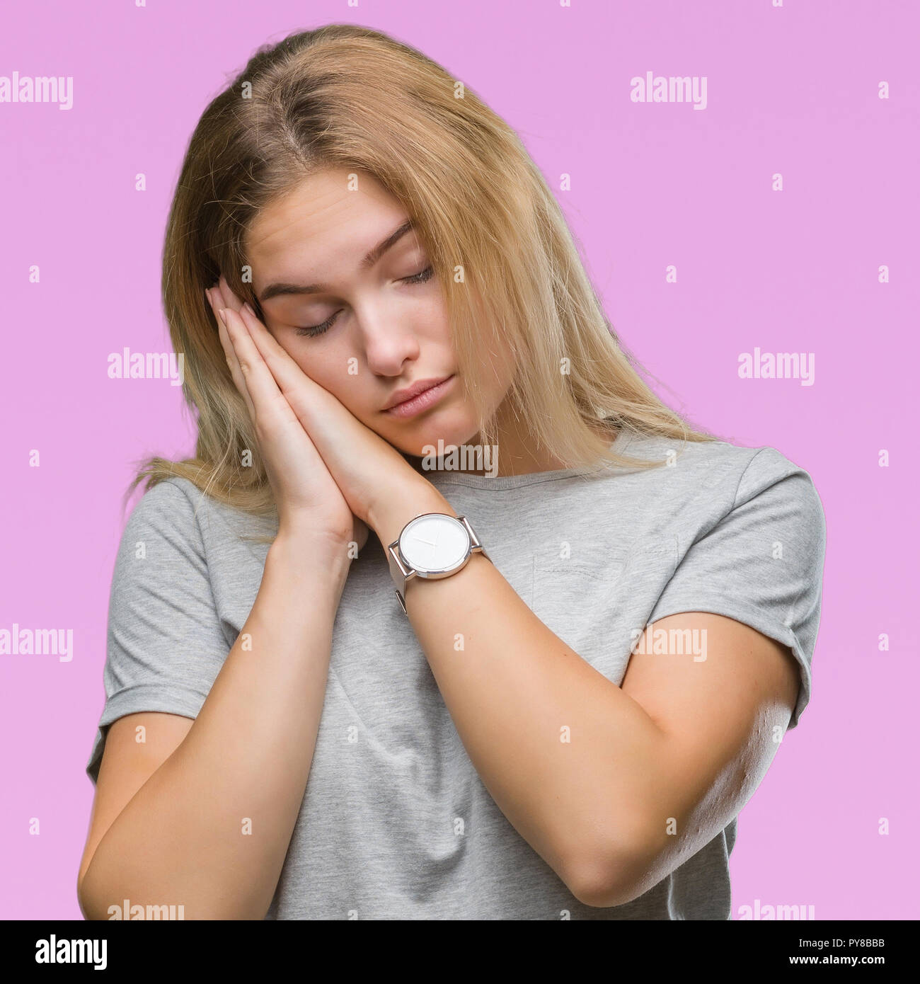 Young caucasian woman over isolated background sleeping tired dreaming ...
