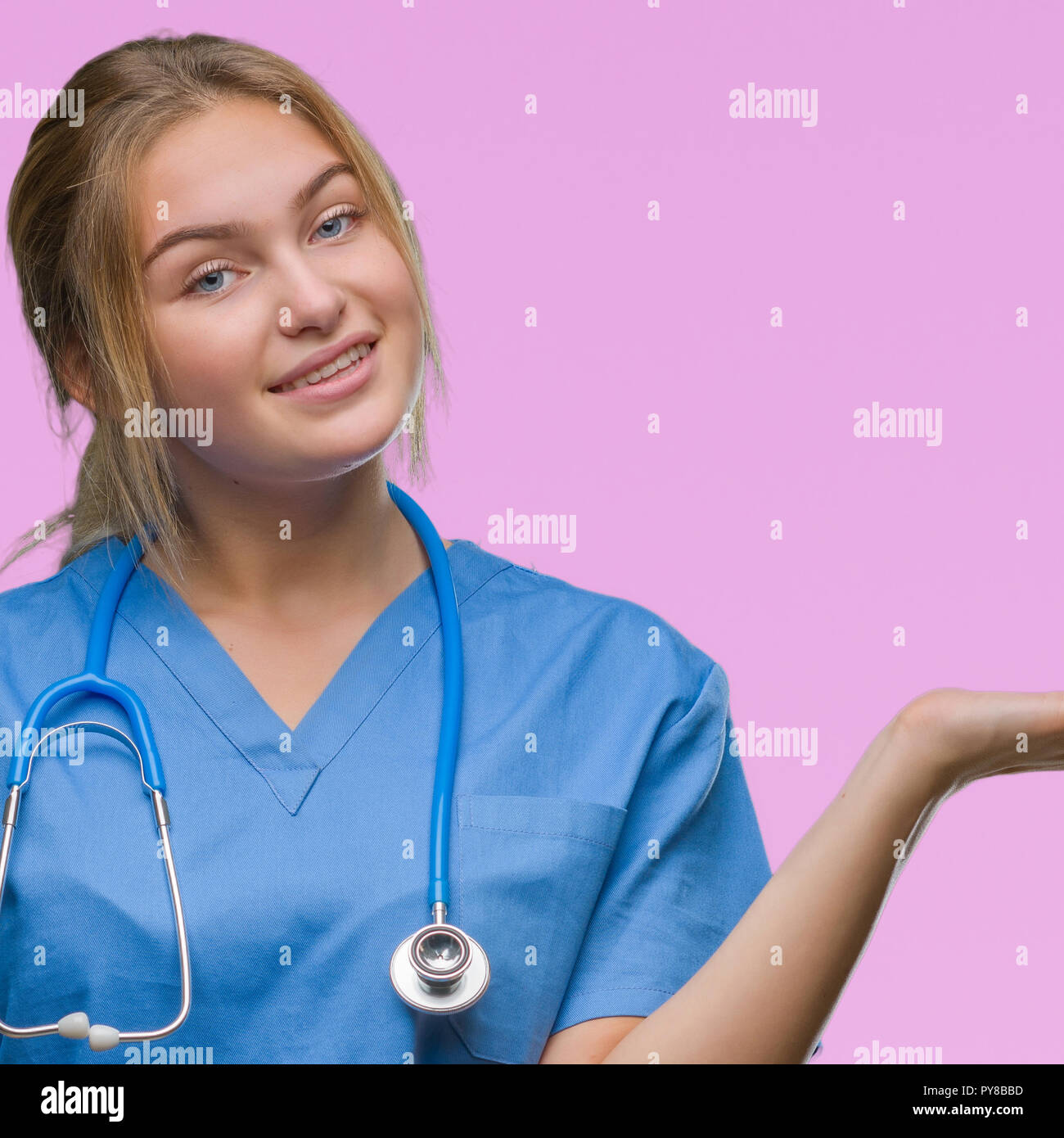 Young caucasian doctor woman wearing surgeon uniform over isolated ...