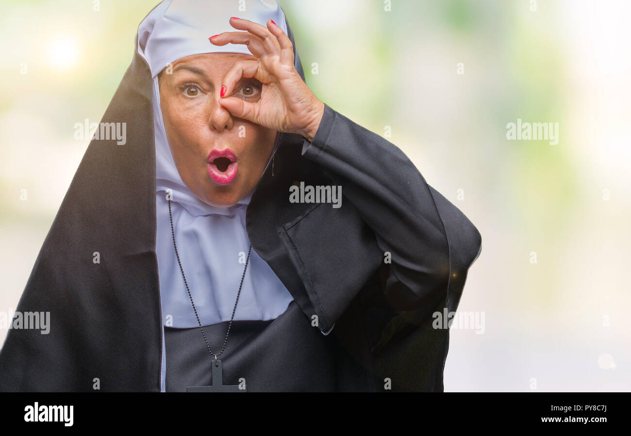 Middle age senior christian catholic nun woman over isolated background ...