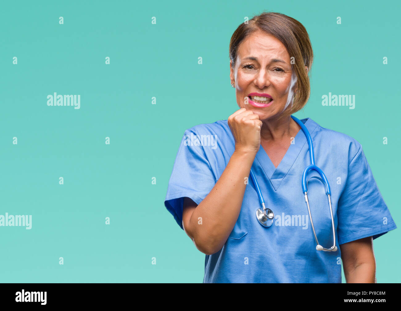 Middle age senior nurse doctor woman over isolated background looking ...