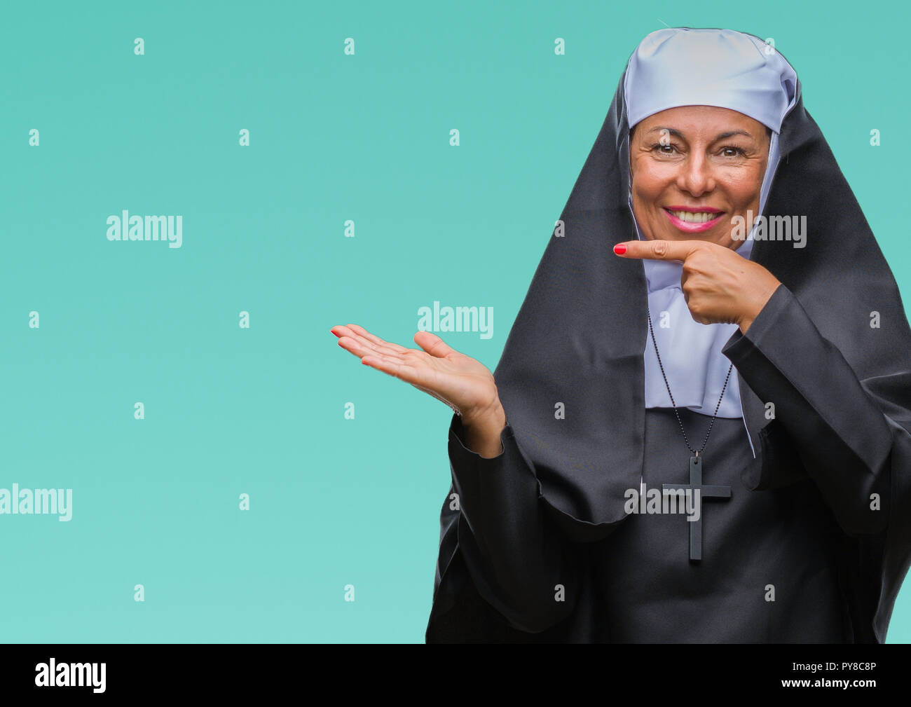 Middle age senior christian catholic nun woman over isolated background ...