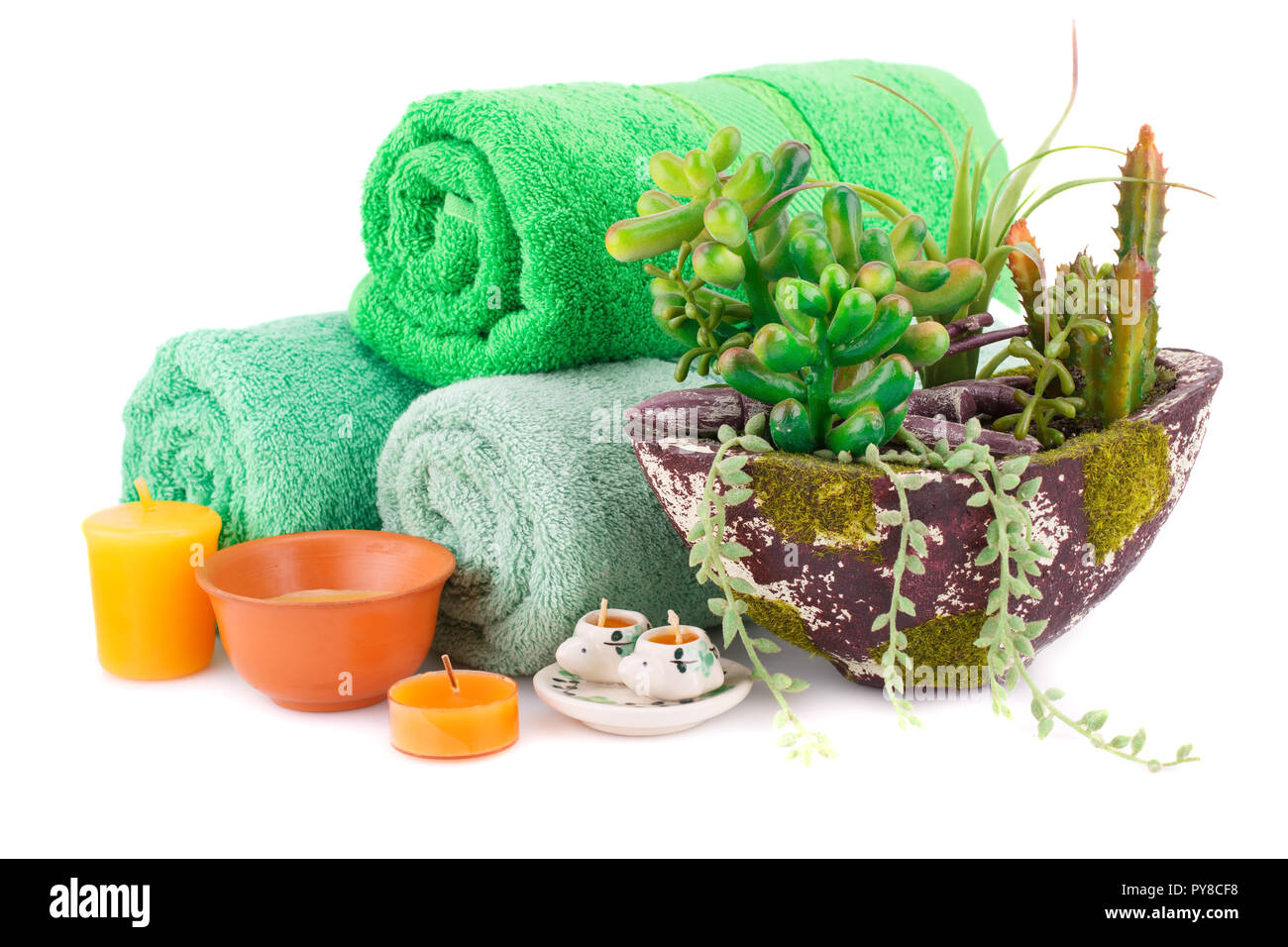 Spa set with towels, candles and plant in vase isolated on white ...
