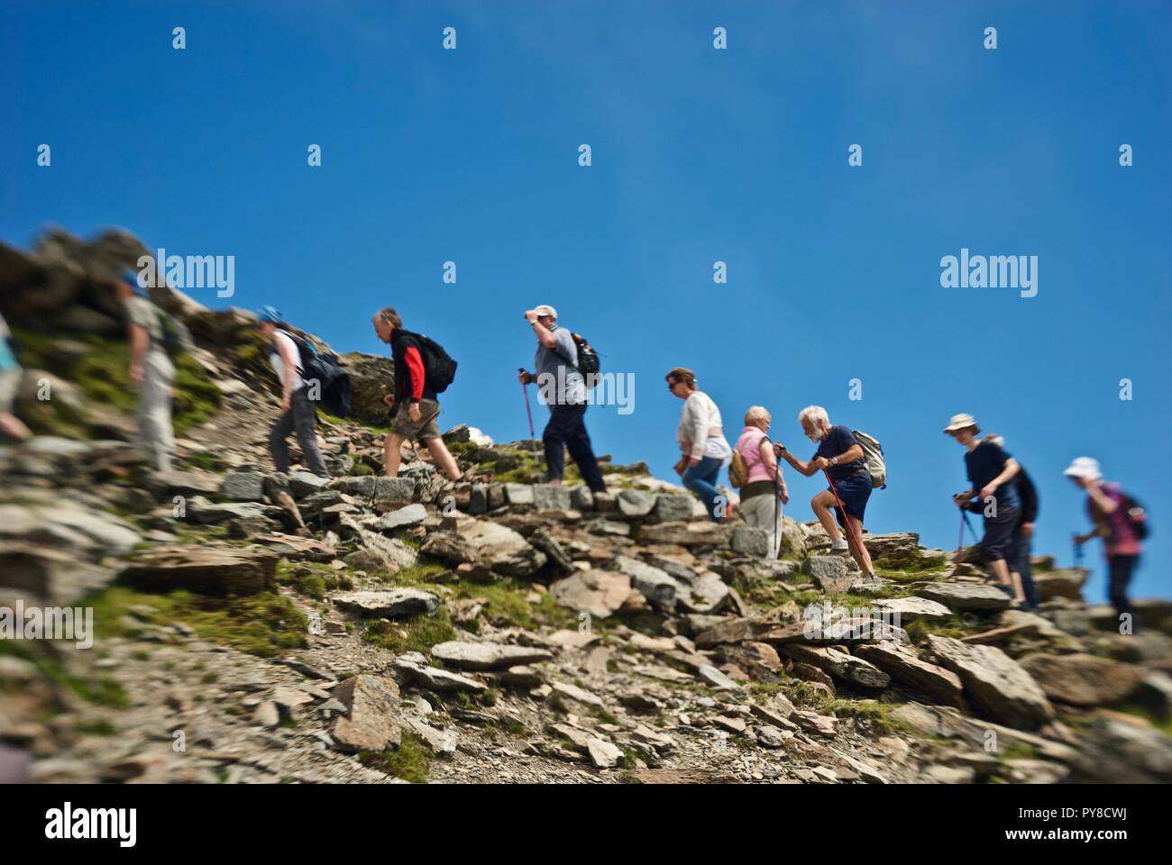 A procession of walkers approaches the summit of Mount Snowdon ...