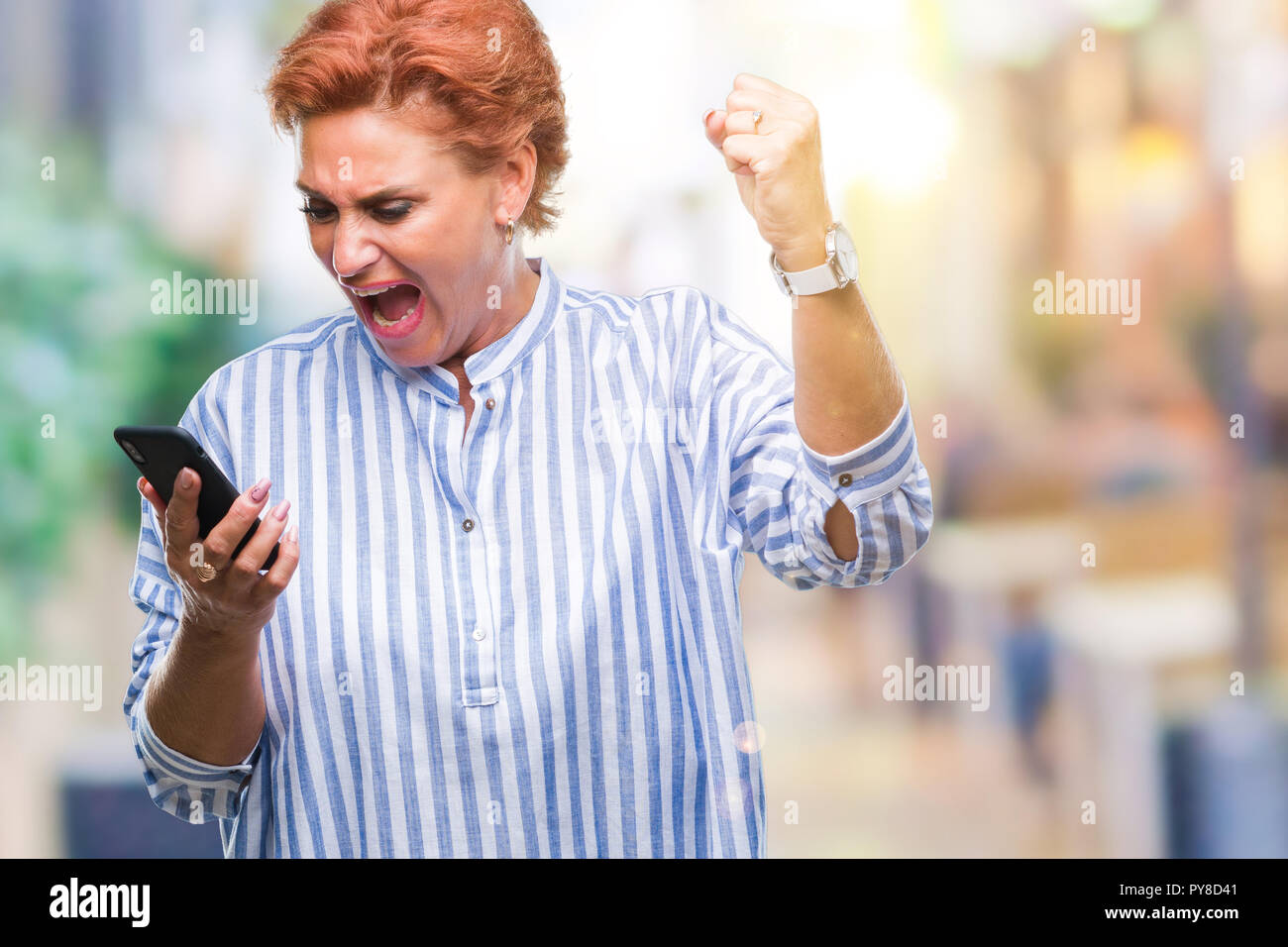 Atrractive senior caucasian redhead woman texting using smartphone over ...