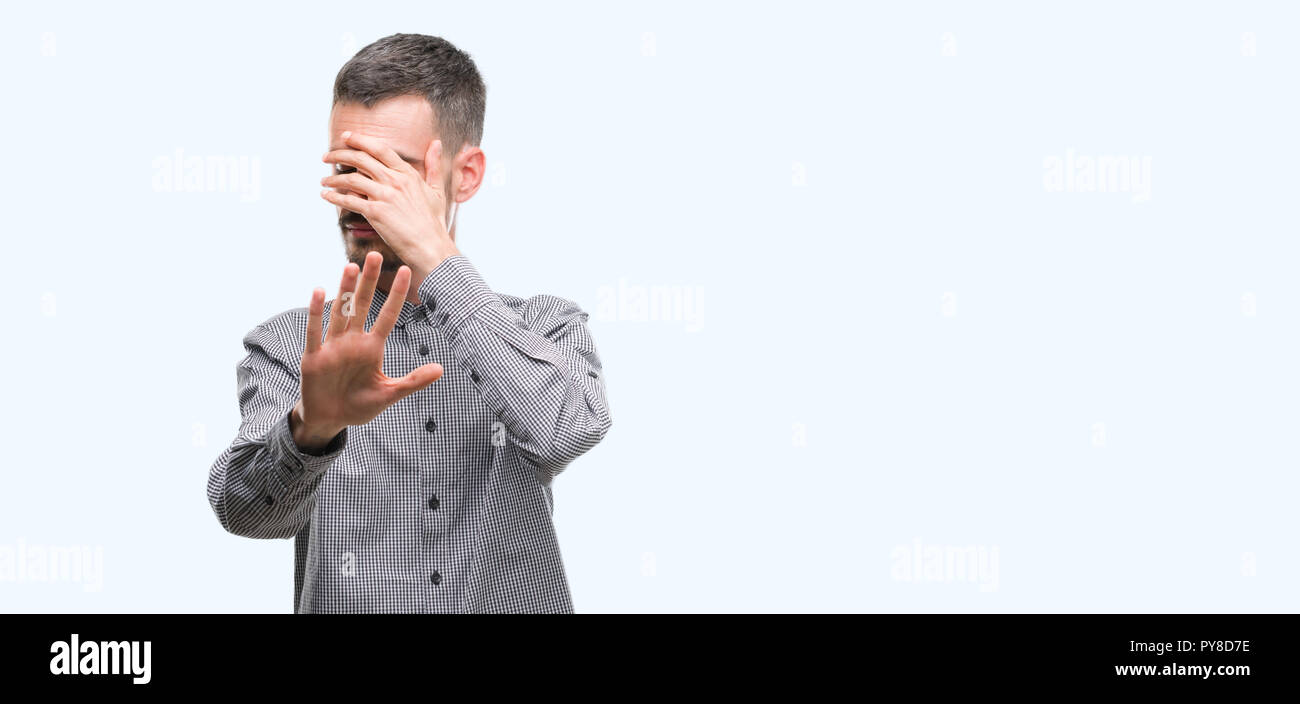 Young hipster man covering eyes with hands and doing stop gesture with ...