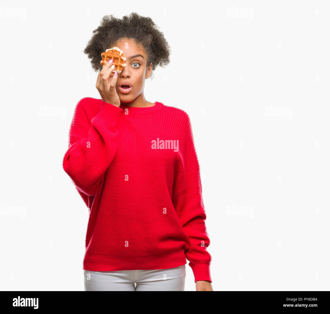 Young beautiful afro american woman eating waffle over isolated ...